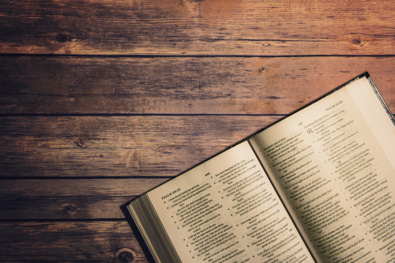 The Holy Bible on wooden table, a Photo by Javier Art Photography