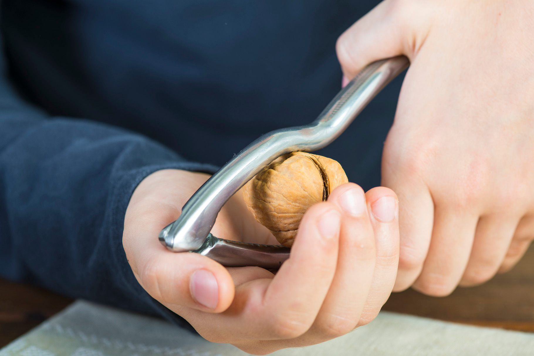 Child cracking walnuts featuring walnut, nut, and food, a Food & Drink ...