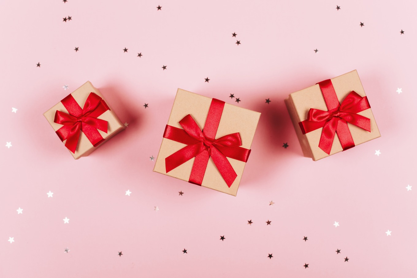 Three presents with red bow on pink, a Holiday Photo by Anna Efetova