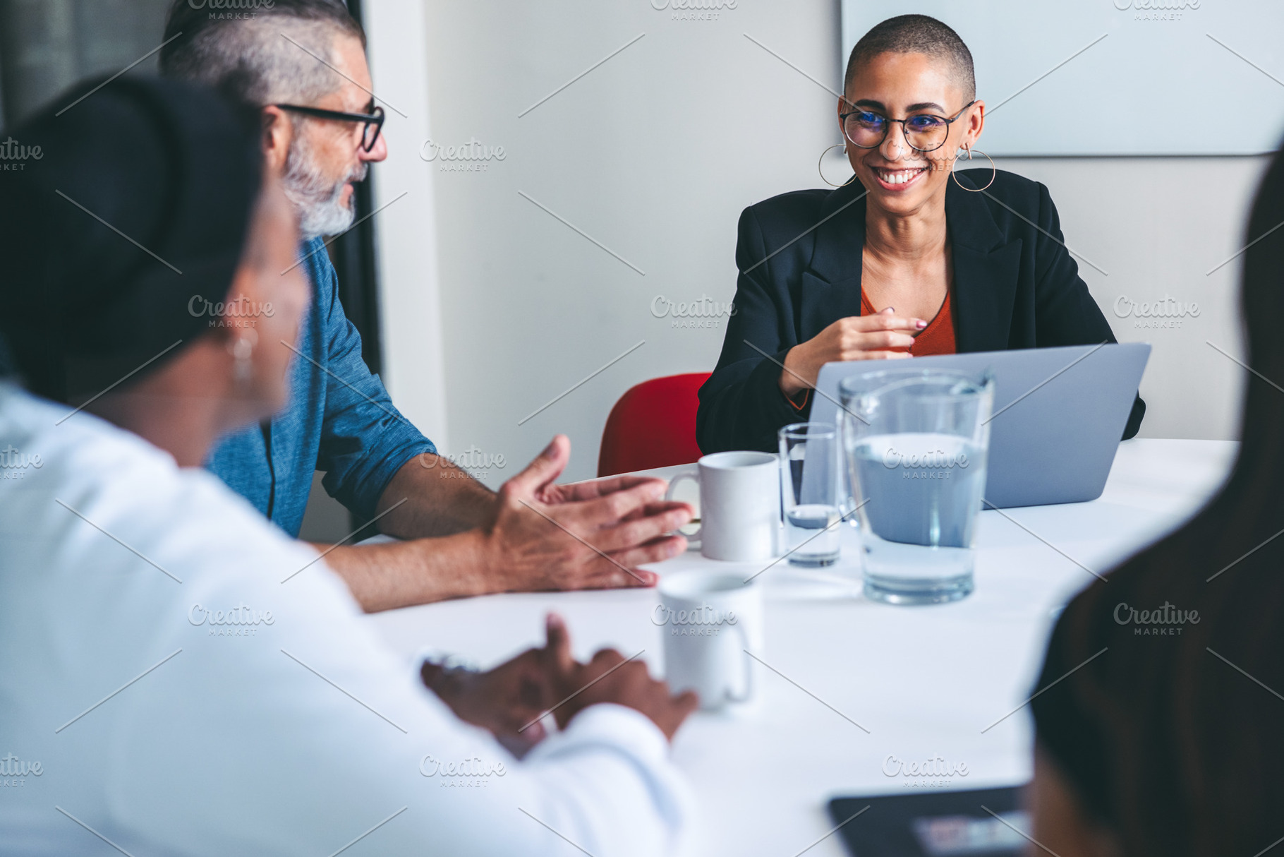 Diverse businesspeople having a briefing in a modern office, a Person ...