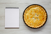 A Piece of Chicken Pot Pie, blank notepad on a white wooden surf, a ...