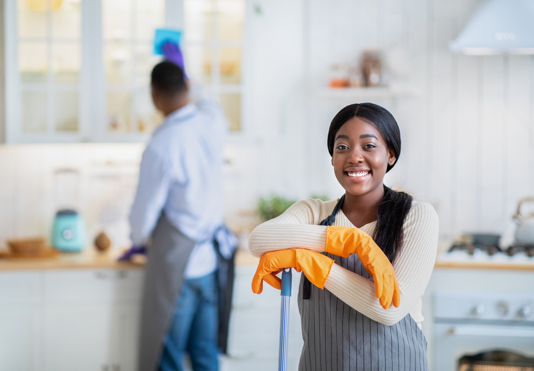 Portrait of happy African American woman with mop ready for cleanup ...