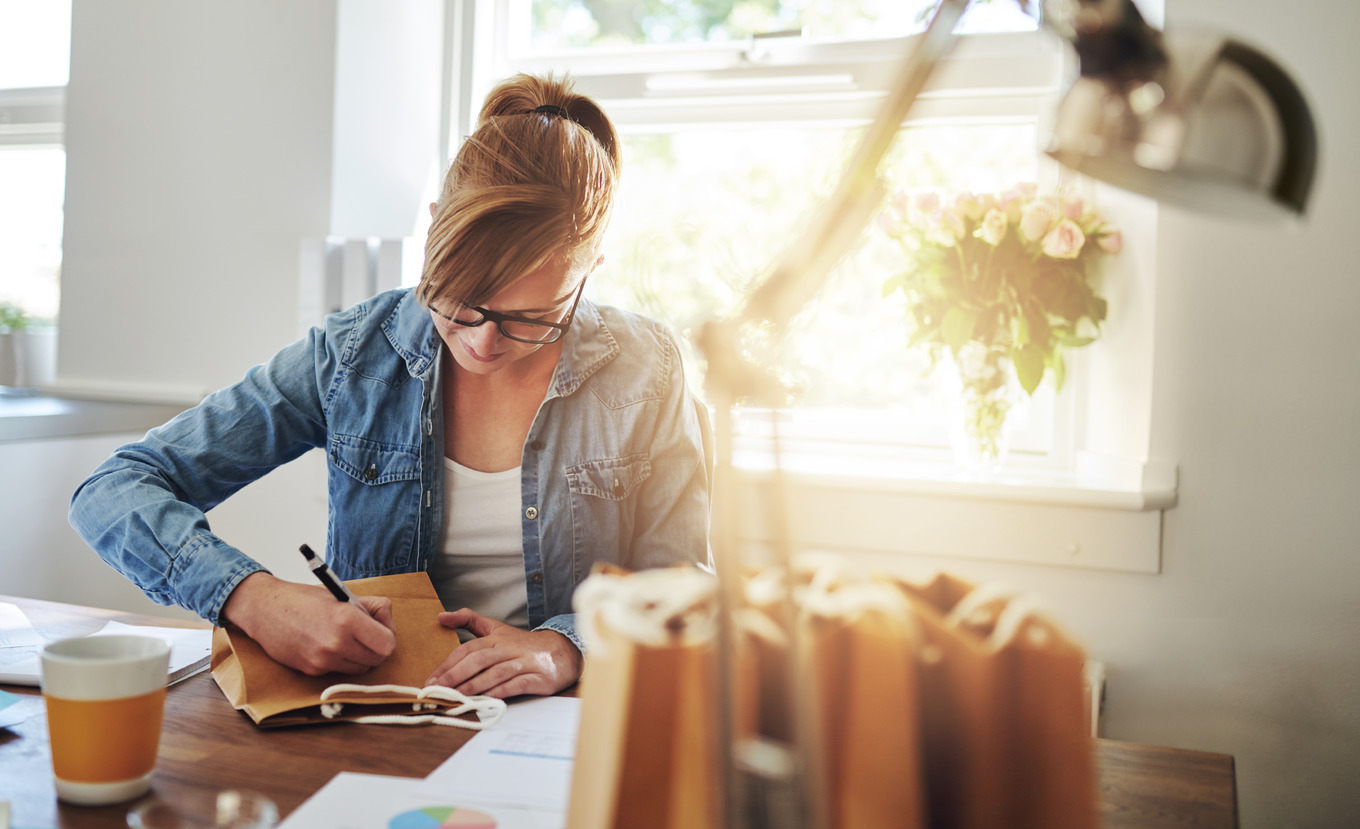 Woman Writing Notes On Package, a Business Photo by Stefan & Janni