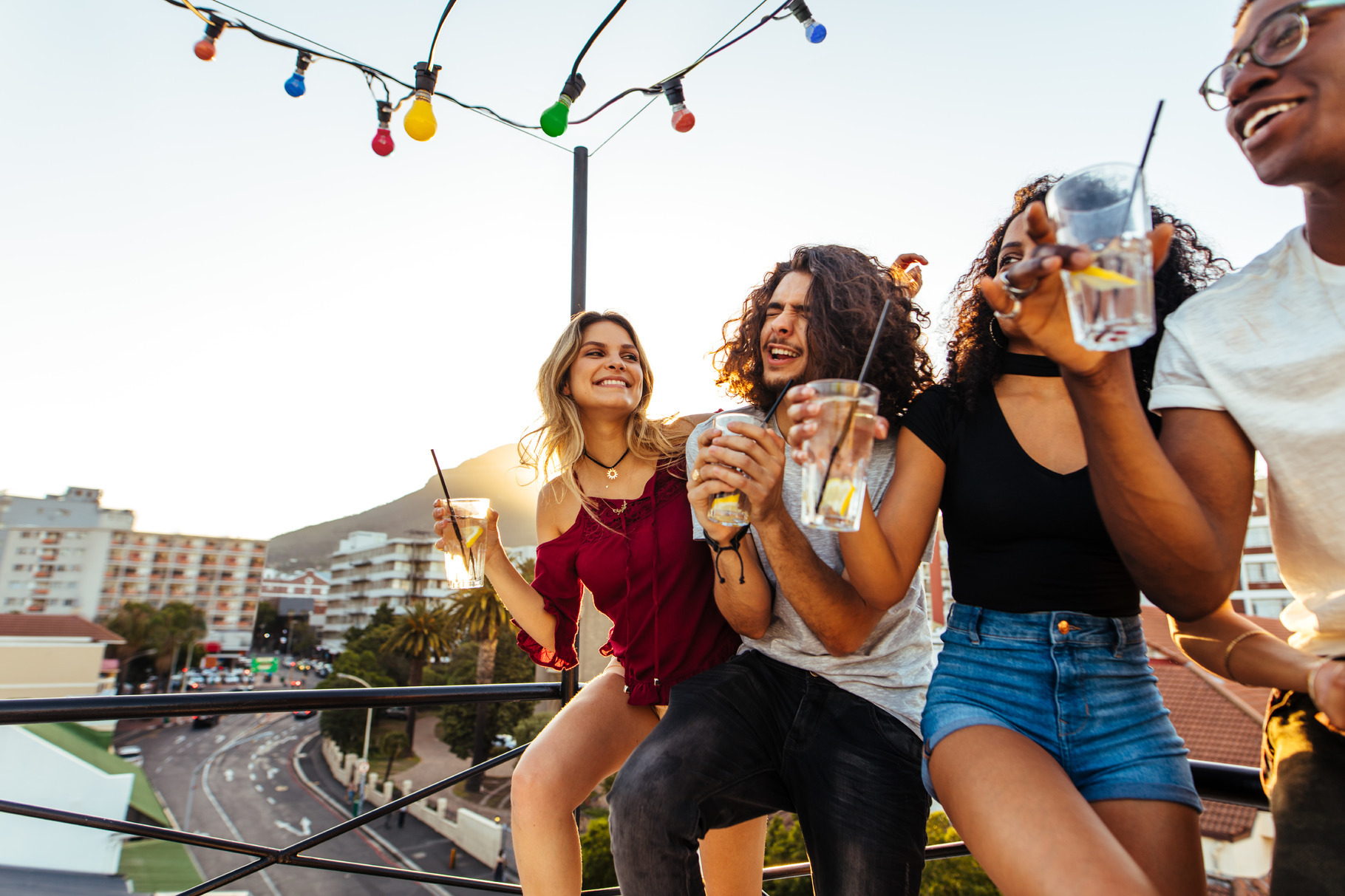 Young people partying on terrace featuring balcony, celebration, and ...