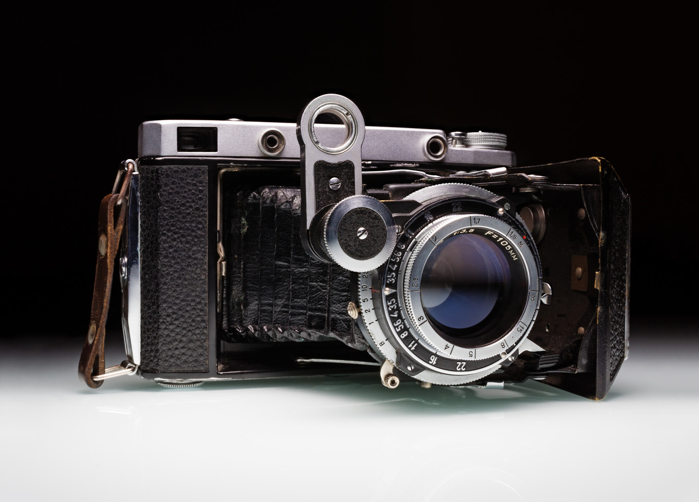 A very old folding bellows camera against a black background studio ...