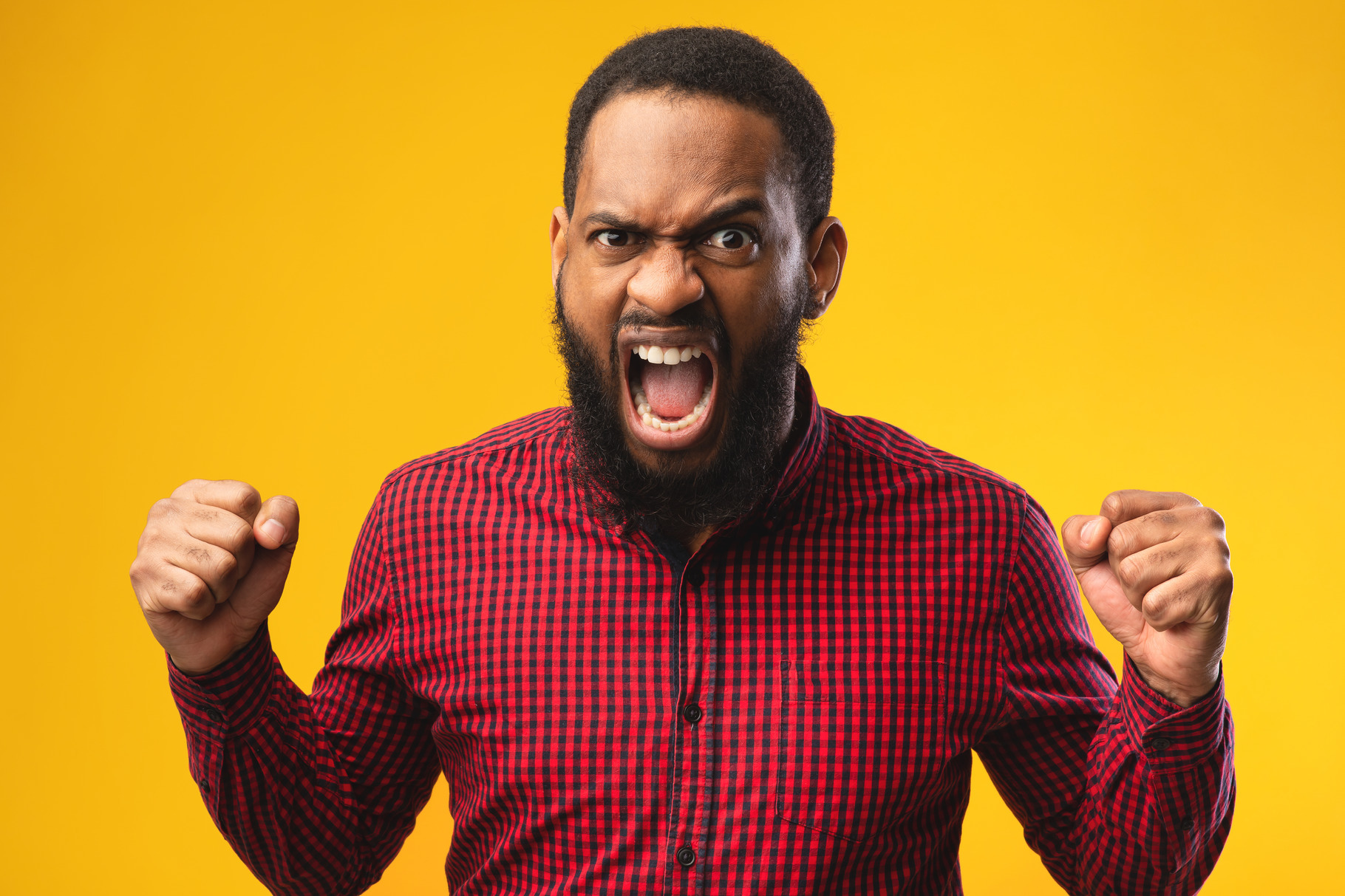 Angry afro man screaming with raised, a Background Photo by Prostock-Studio