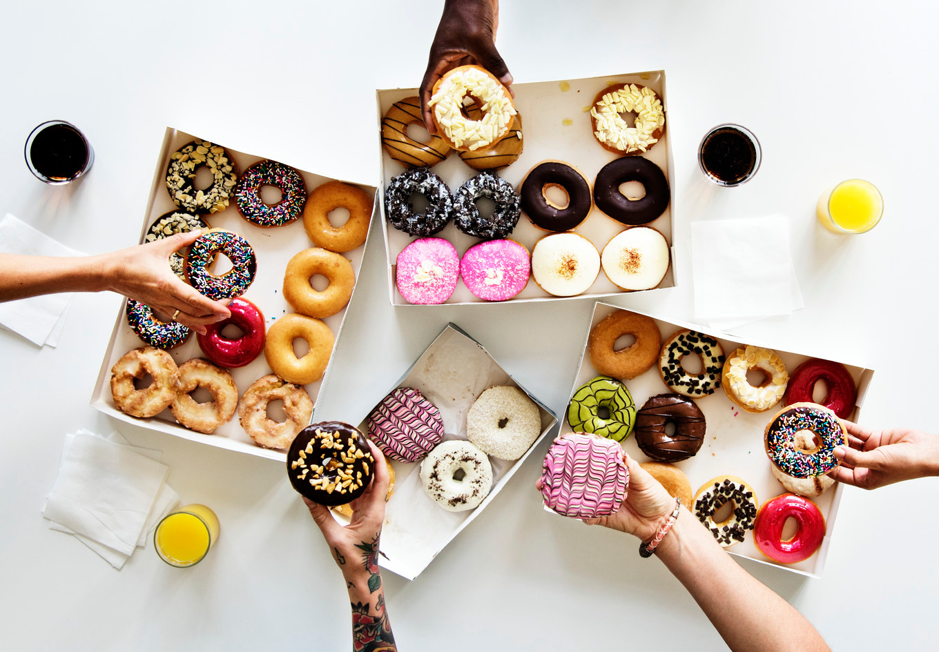 Reaching for donuts featuring person, glossy, and holding | People ...
