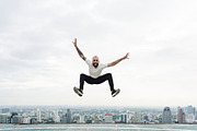 Man Jumping on The Rooftop, a Photo by rawpixel