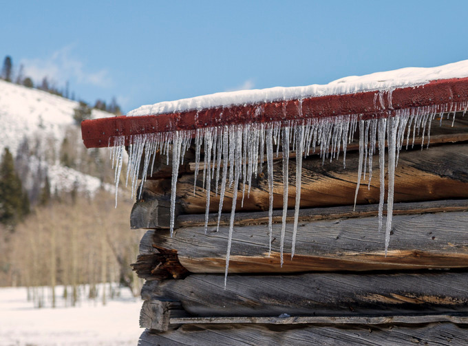 Log cabin and ice sickles featuring winter, snow, and cold, an ...