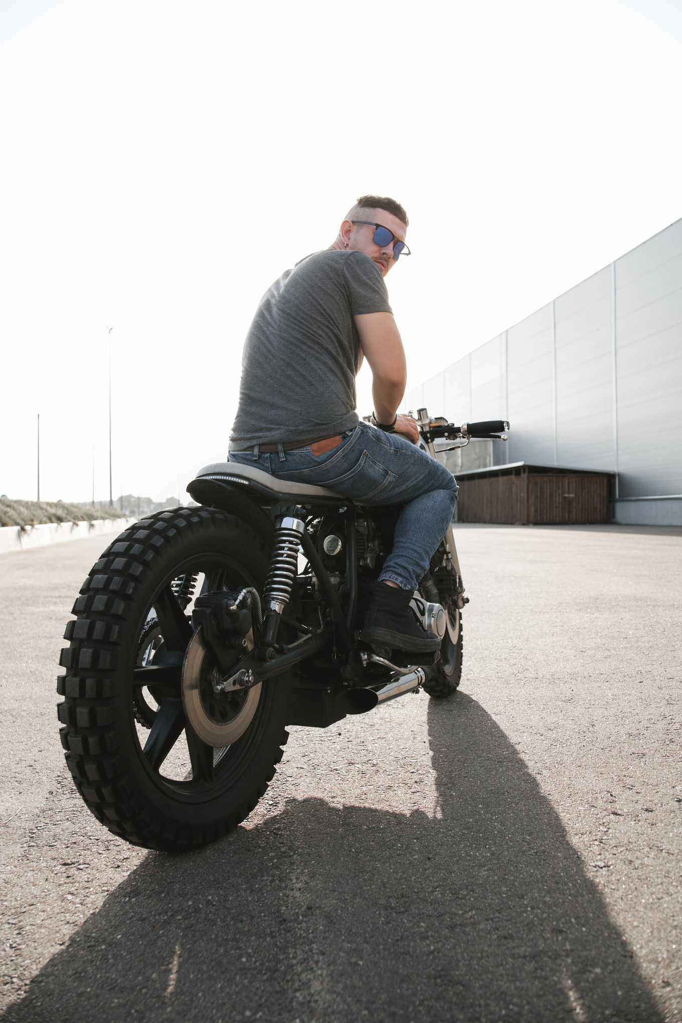 Rider guy with classic style cafe racer motorcycle featuring background ...