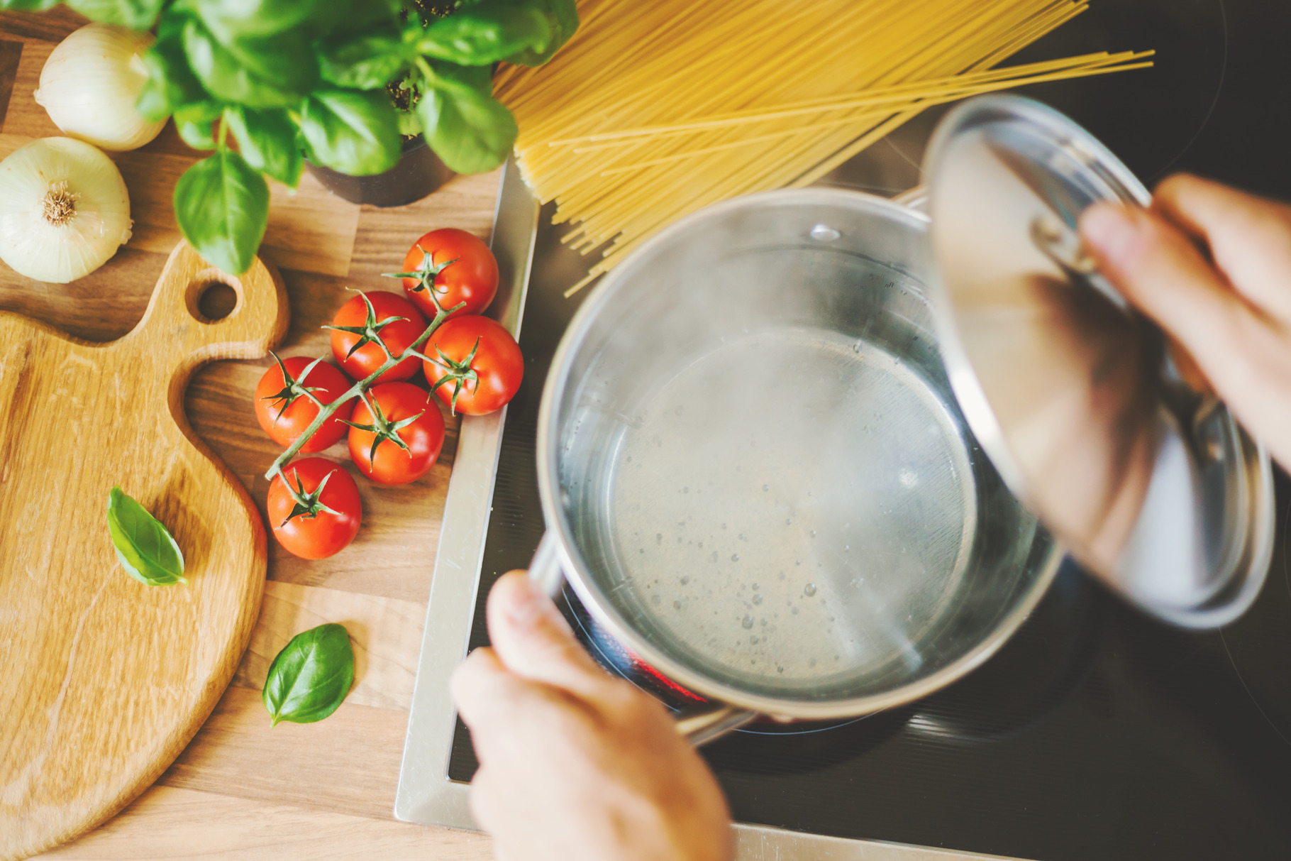 Man cooking pasta in boiling water containing pasta, cooking, and water ...