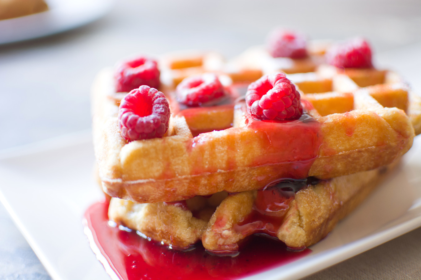 Waffles with raspberries containing waffles, strawberry, and berry, a ...