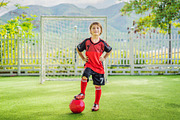 Little cute kid boy in red football containing boy, football, and field ...