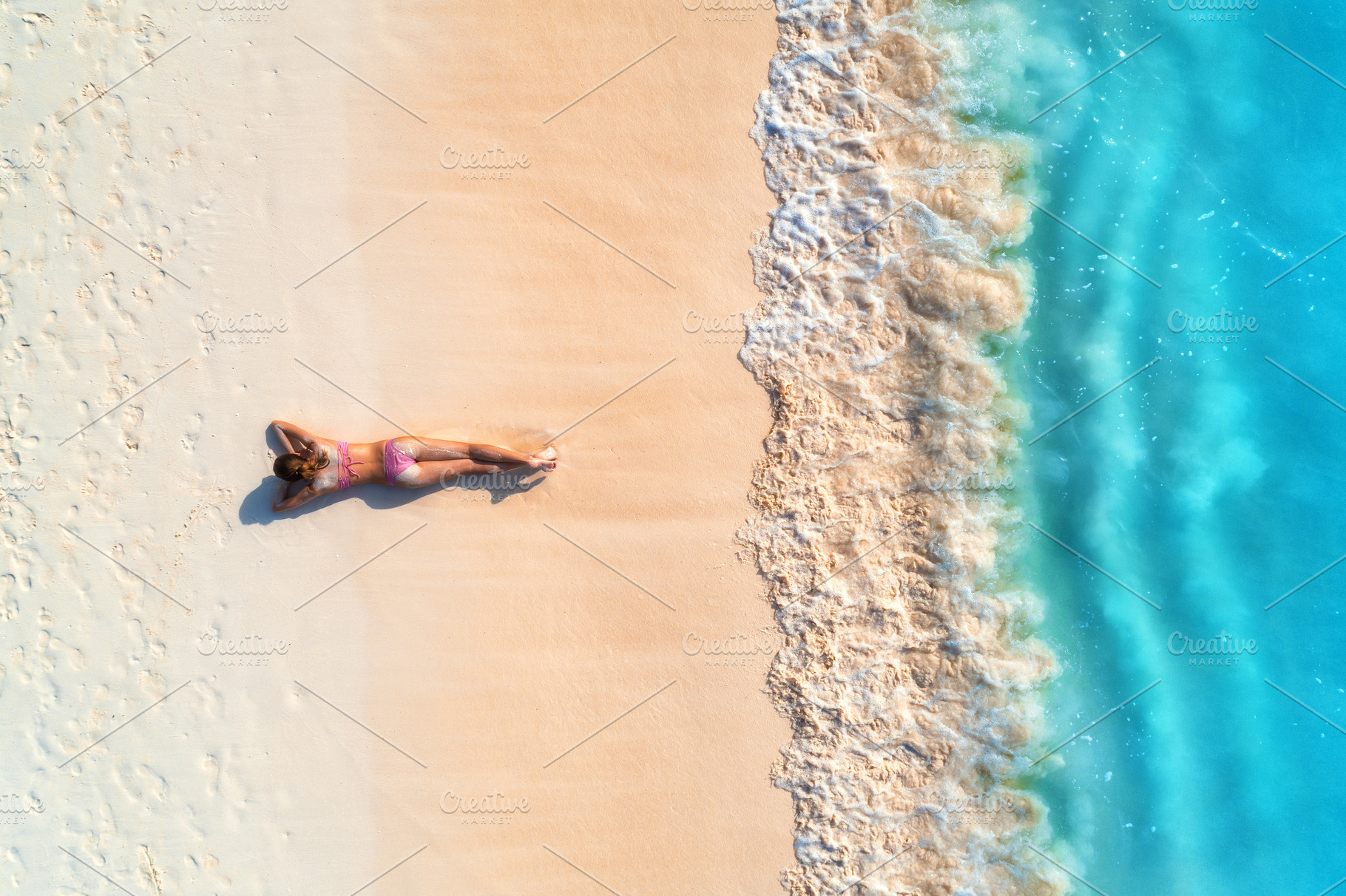 Aerial view of woman on the beach featuring girl, woman, and water, a ...