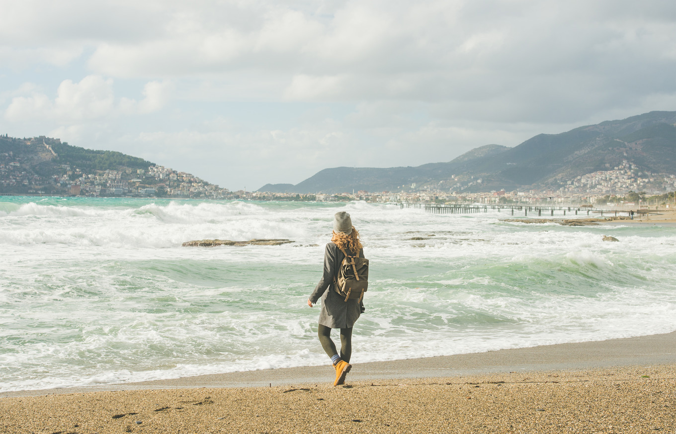 Traveler walking on sandy beach, a Nature Photo by Foxys