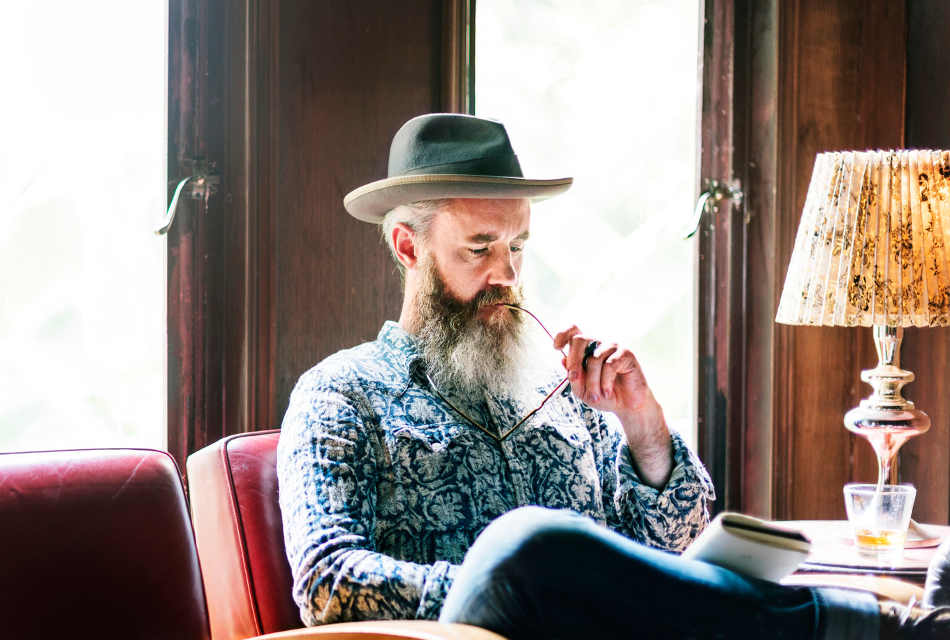 Man sitting and writing in cafe, a Photo by rawpixel