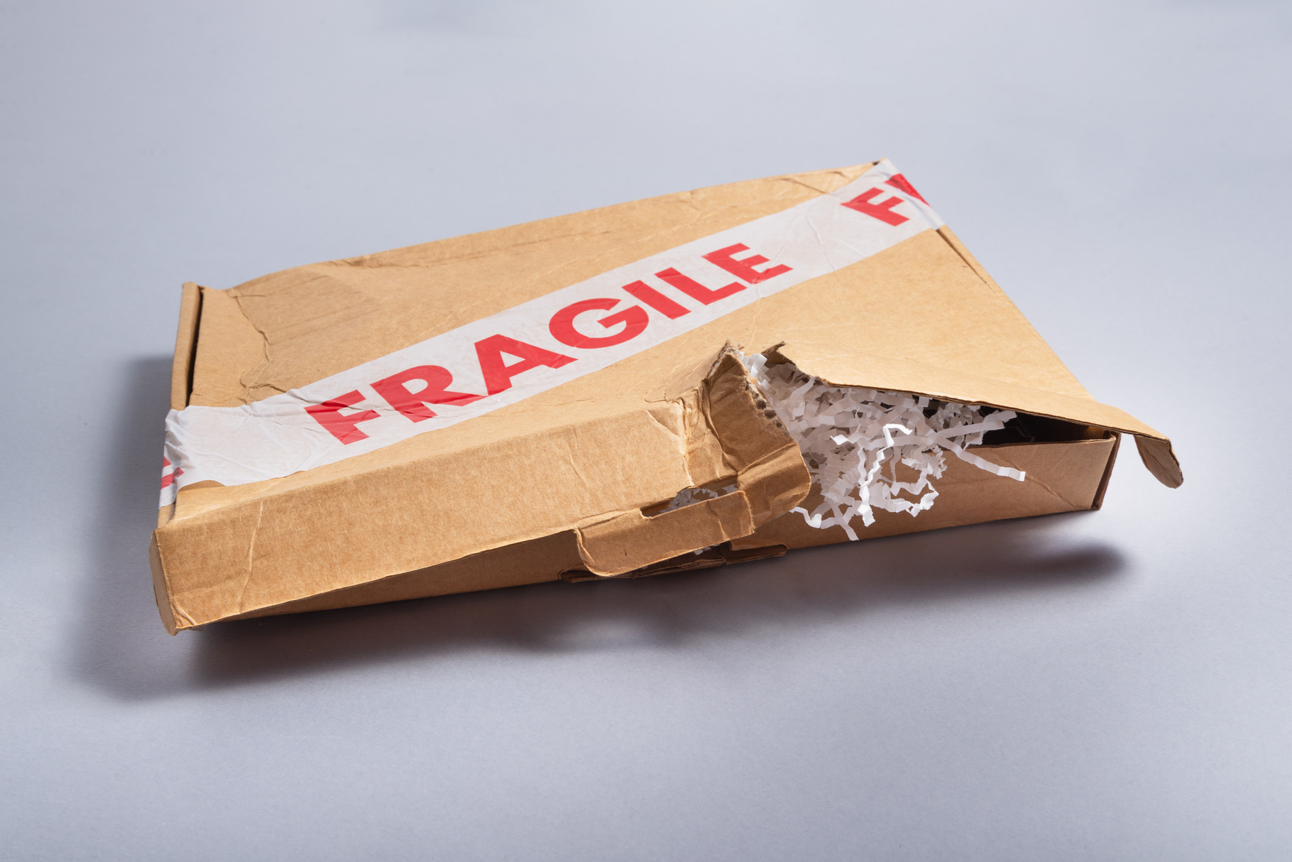 Broken fragile parcel, torn cardboard box on office desk, an Industrial ...