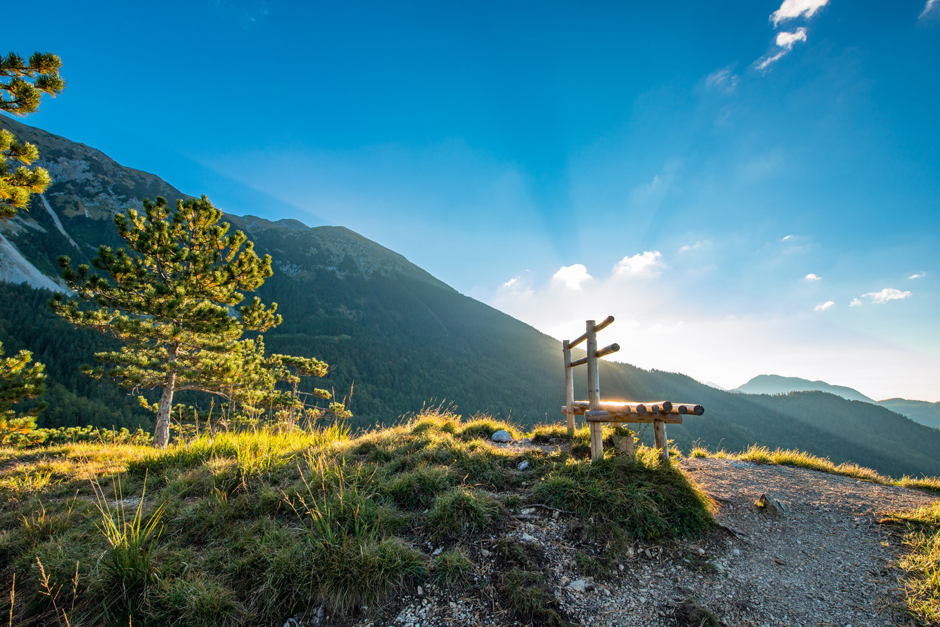 Bench at the top of the hill containing bench, hill, and grass, a ...