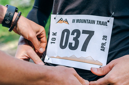 Girl placing the race number featuring race number, running number, and ...