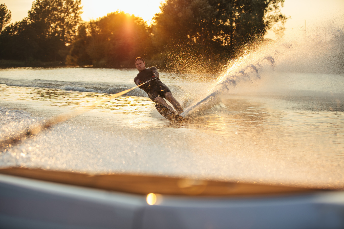Man wakeboarding on lake featuring action, activity, and adventure ...