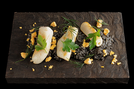 Black risotto cooked with squid ink featuring calamary, calamari, and ...