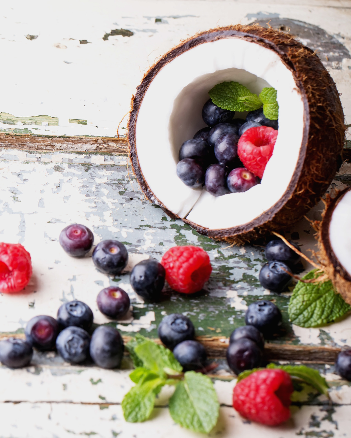 Coconut with berries and mint containing background, bee, and berry, a ...