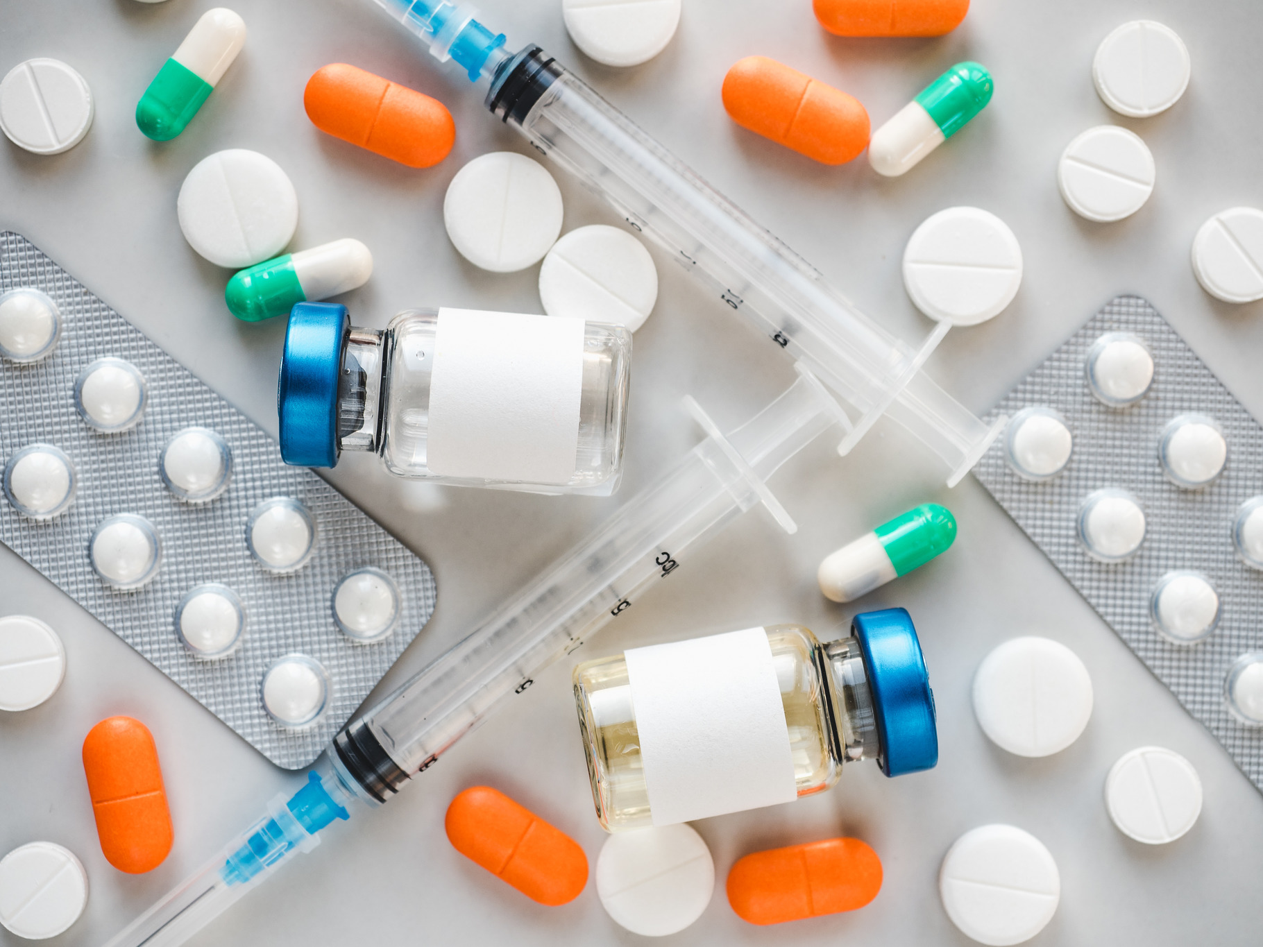 Syringes, injection bottles and tablets lying on the table, a Health ...