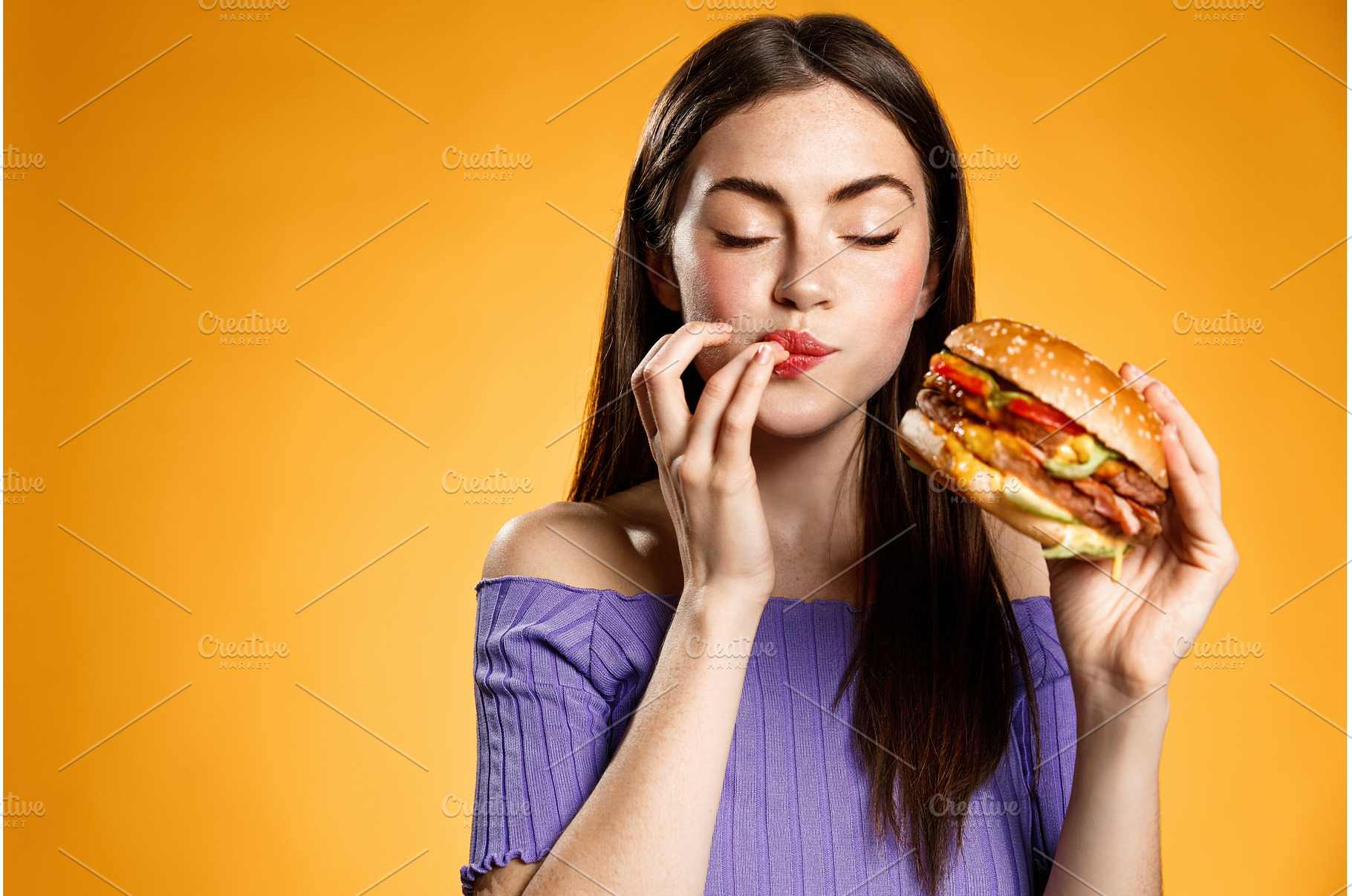 Woman eating cheeseburger with, a Person Photo by ringsaroundme