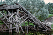 Logs of pillars of old wooden bridge
