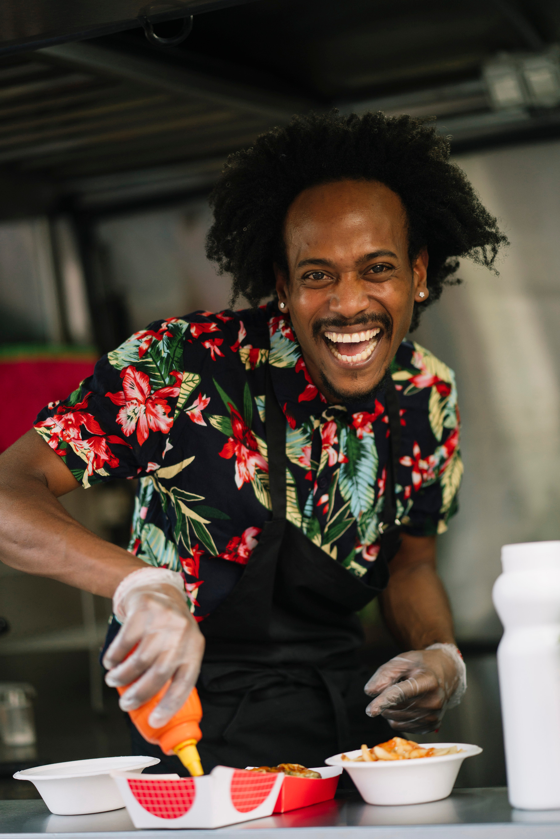 Smiling food vendor hands food to wa containing lunch, takeout, and ...