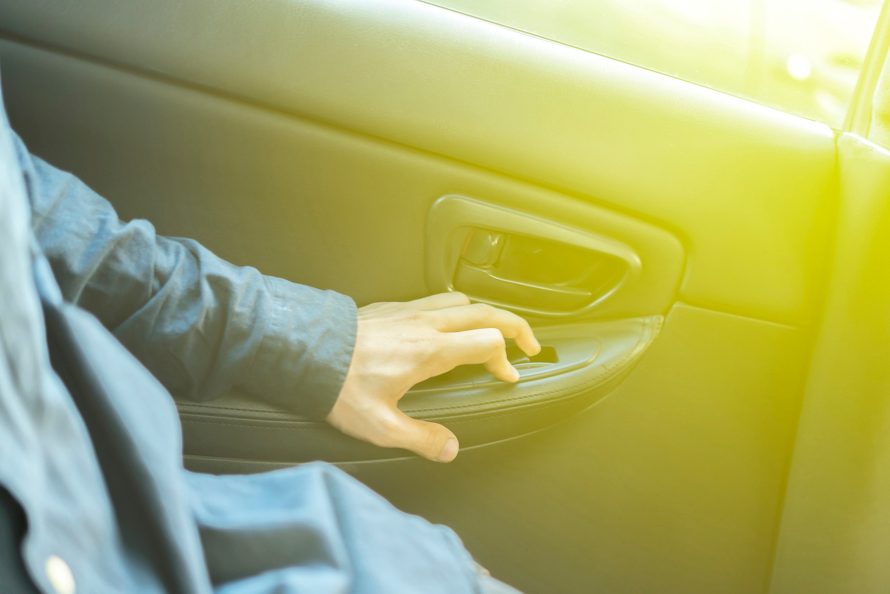 a person sitting inside the car and open the window, finger push the ...