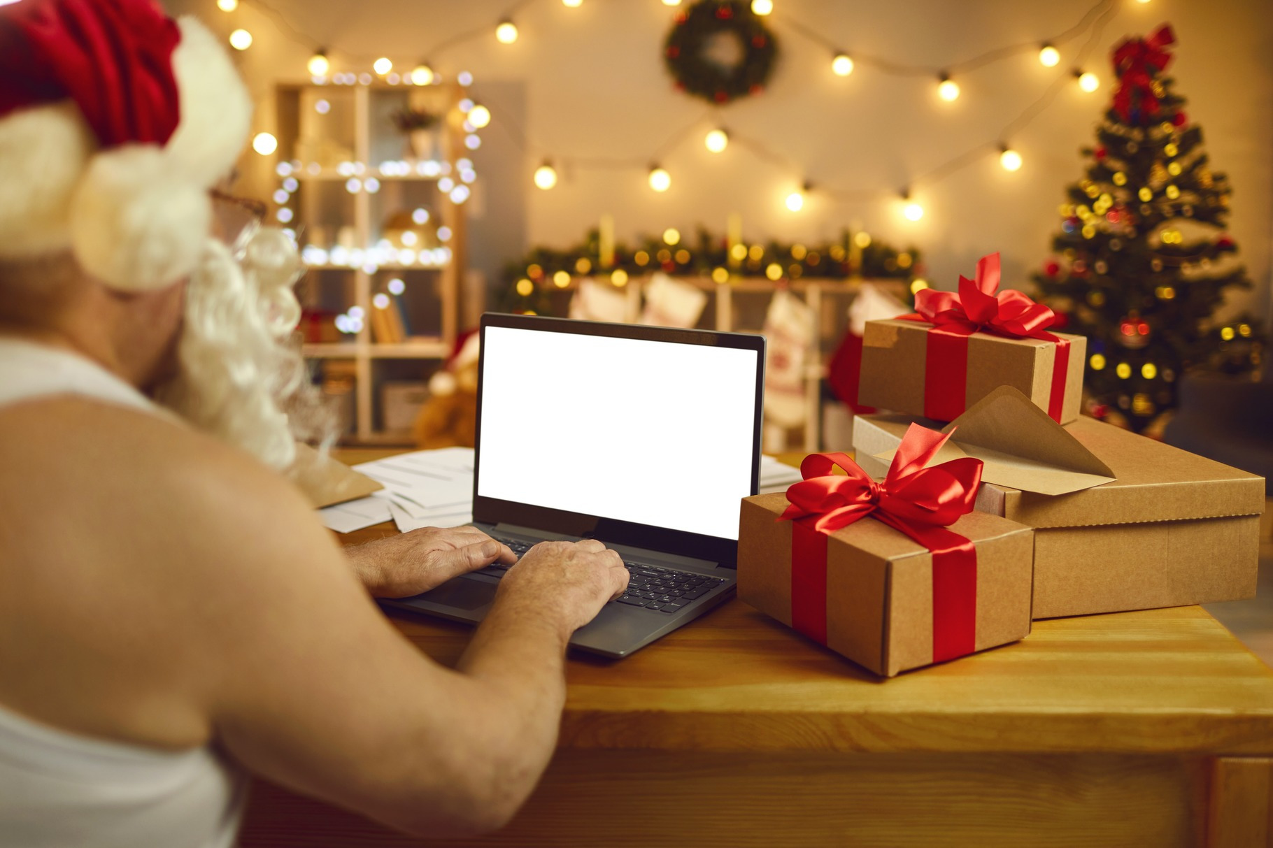 Santa Claus working on laptop with, a Technology Photo by StudioRomantic