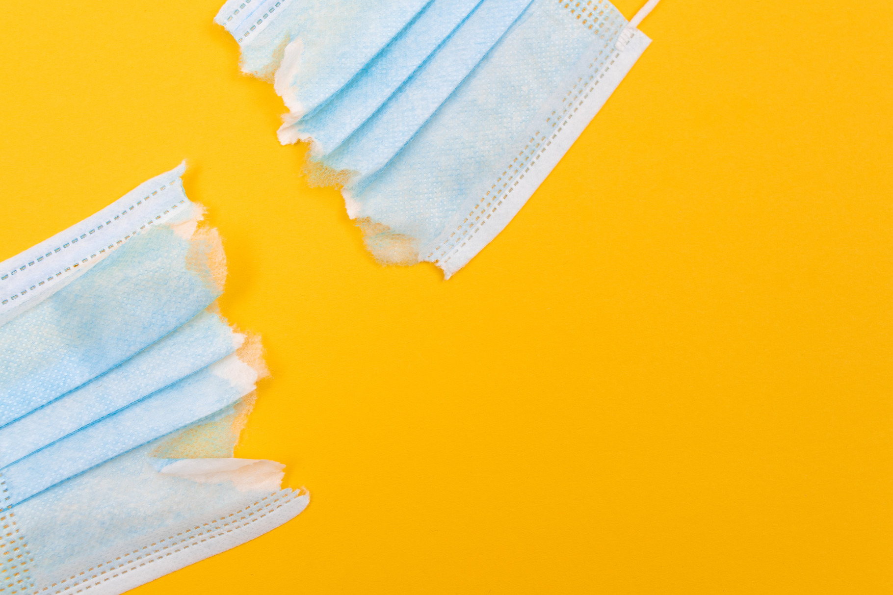 Torn Medical Face Mask Lying on Yellow Table, a Photo by ...