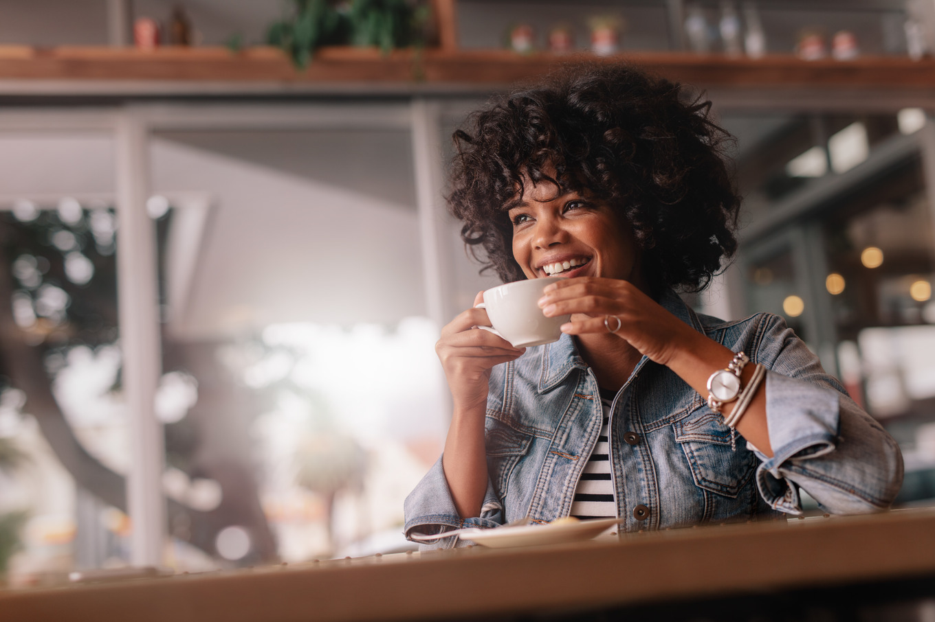 Smiling young female having coffee, a Person Photo by Jacob Lund