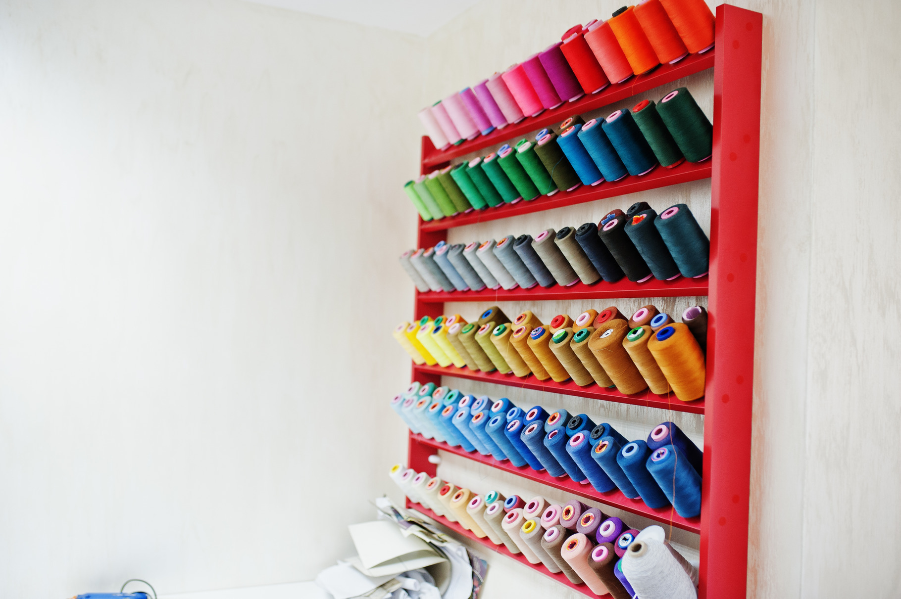 Colored thread coils on seamstess ba featuring background, black, and ...