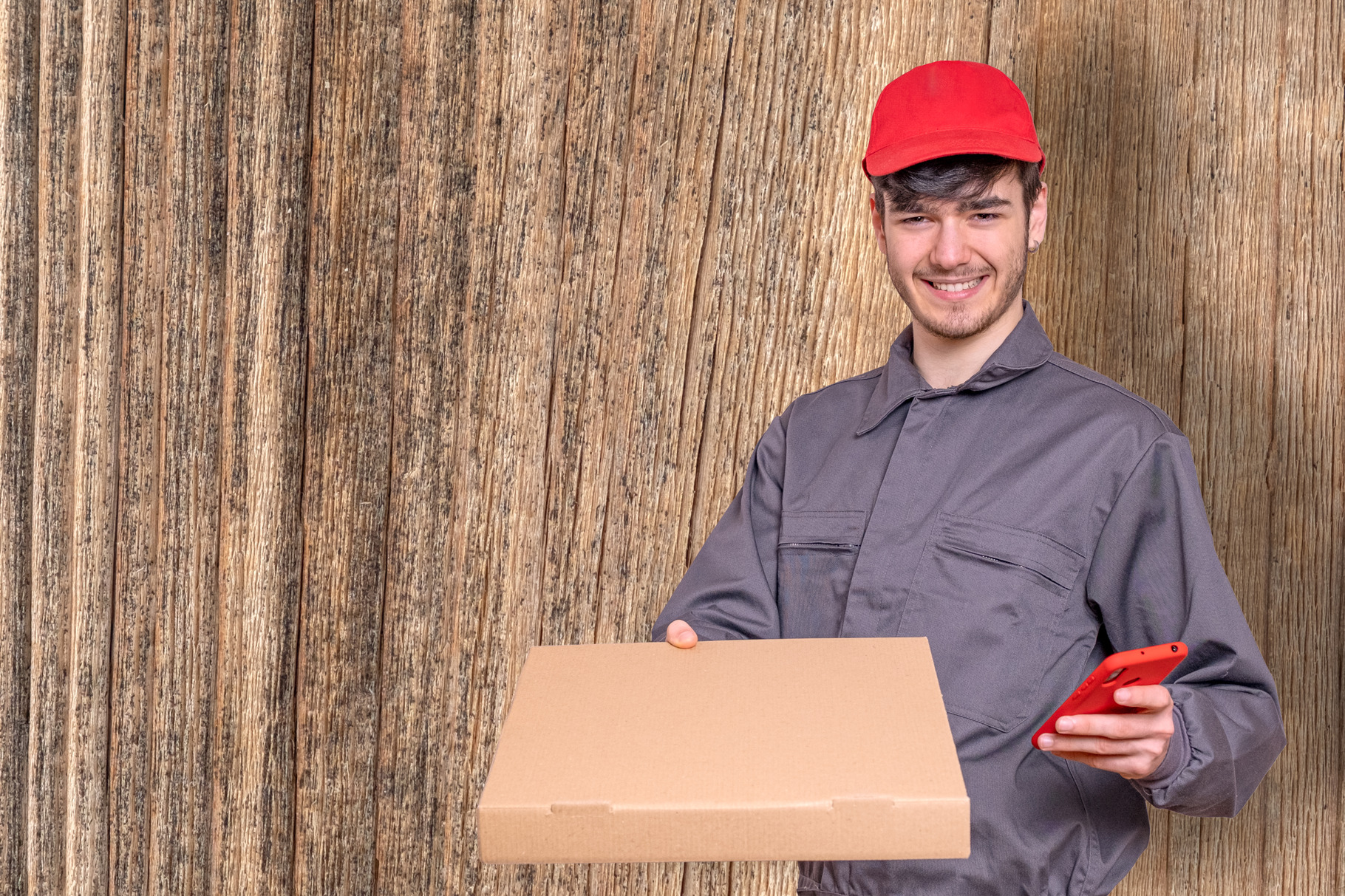 Delivery man in uniform delivering pizza to homes, fast food doo ...