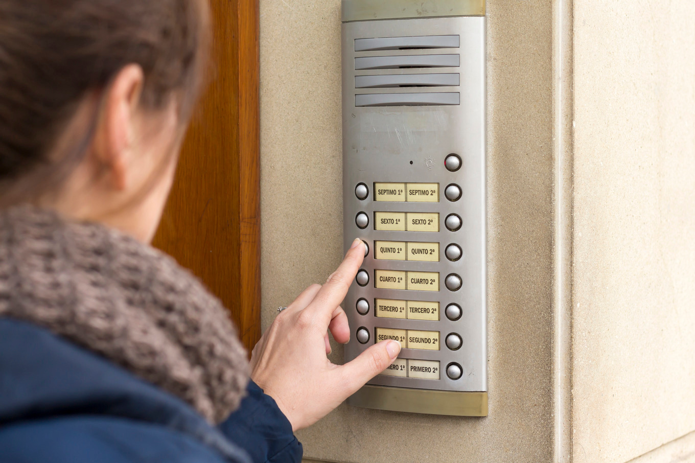Woman talking on the intercom containing access, adult, and alarm, a ...