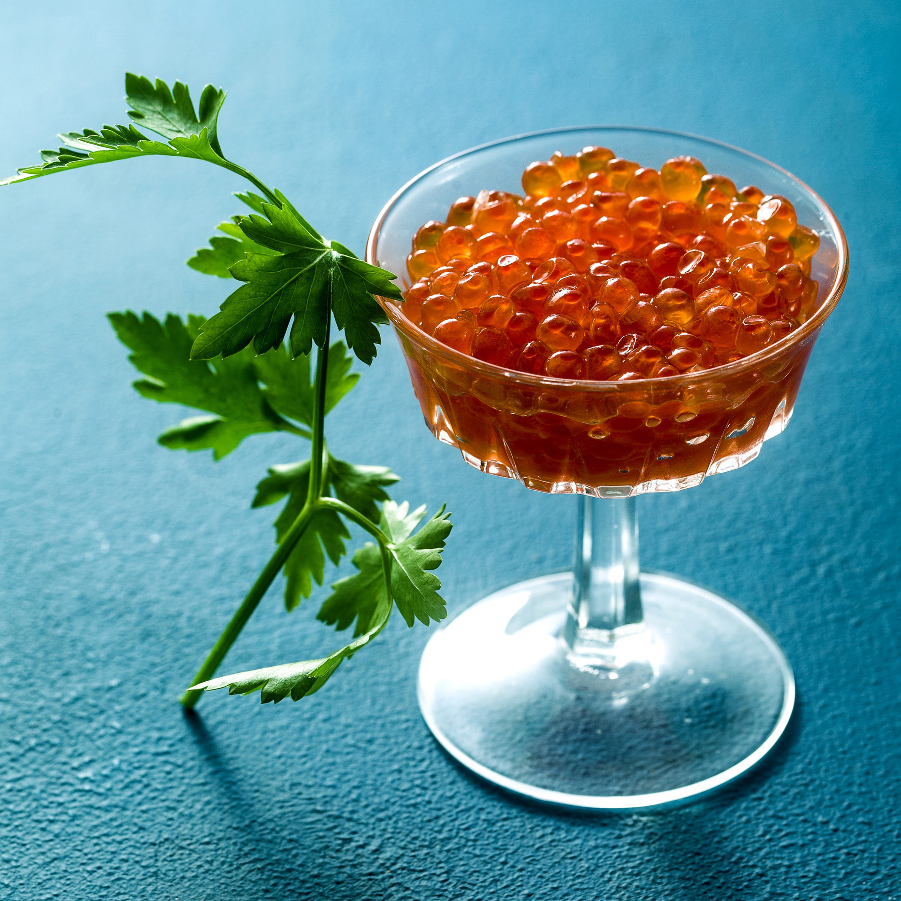 Portion of red caviar on the table featuring caviar, red, and ...
