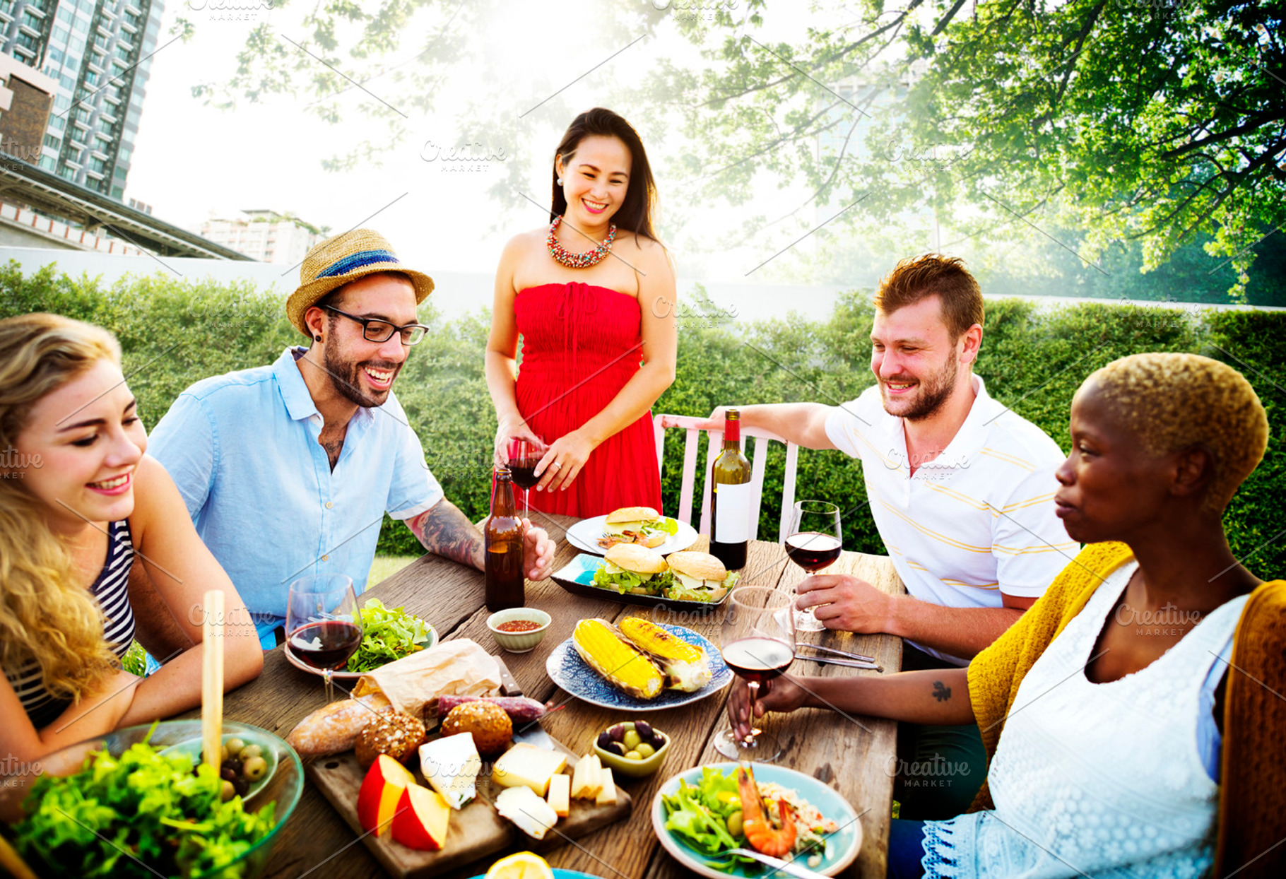 Diverse friends eating together, a Photo by rawpixel | Creative Market