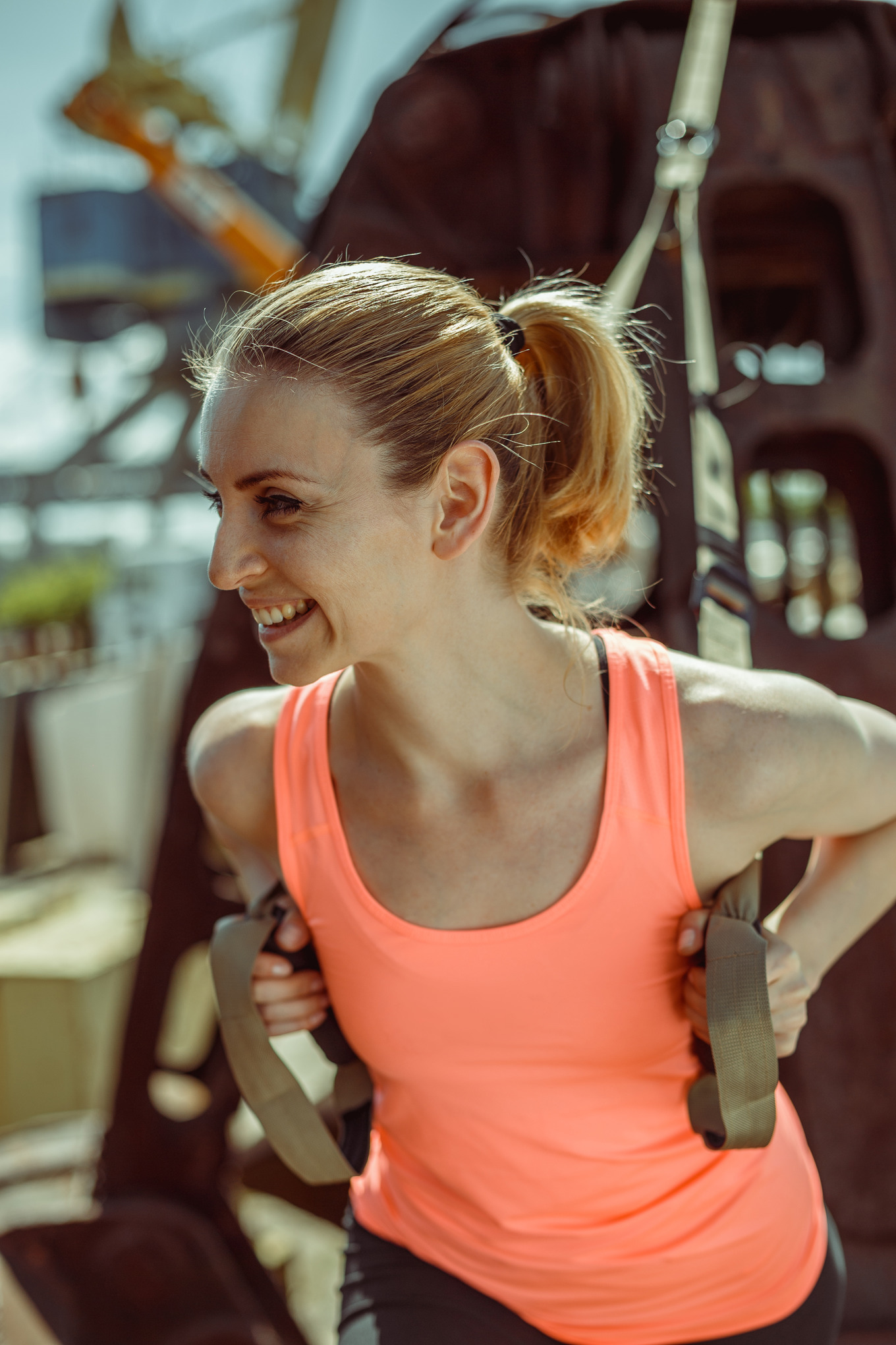Closeup portrait of an athlete in uniform during exercise with trx ...