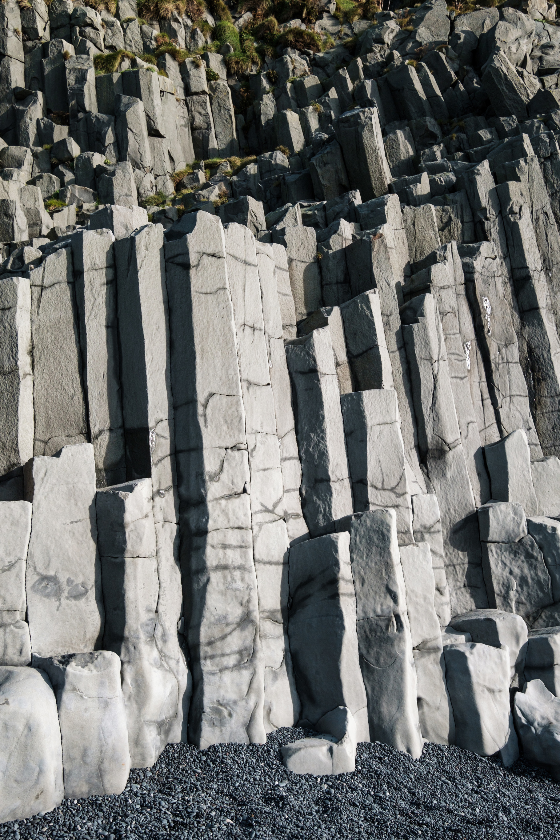 Basalt rock pillars columns at Reynisfjara beach near Vik, South, a ...