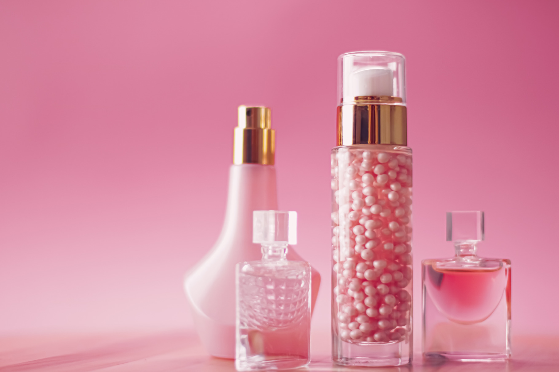 Perfume bottles and make-up gel on pink background, luxury beaut, a ...