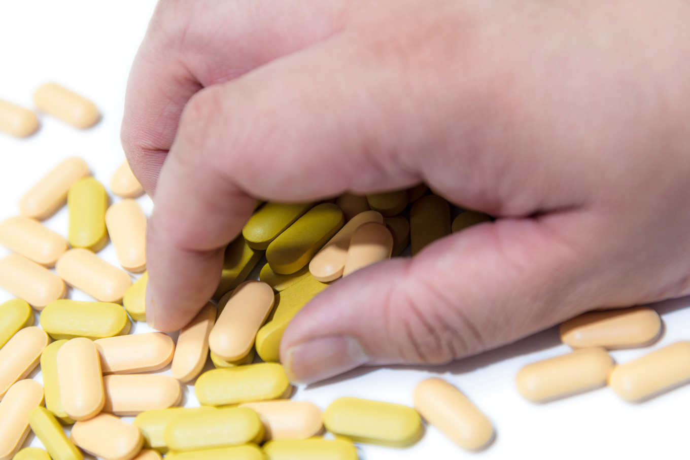 Male Hand Grab Vitamin C tablet, a Health & Medical Photo by PeoGeo Studio