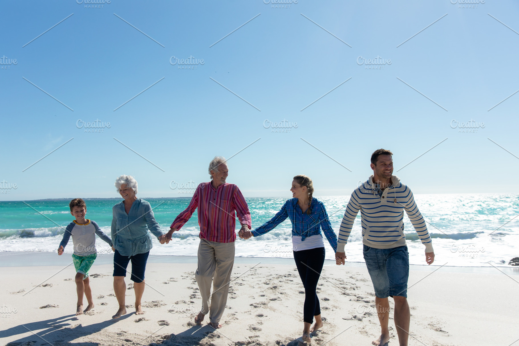 Family walking together at the beach, a Photo by wavebreak | Creative ...