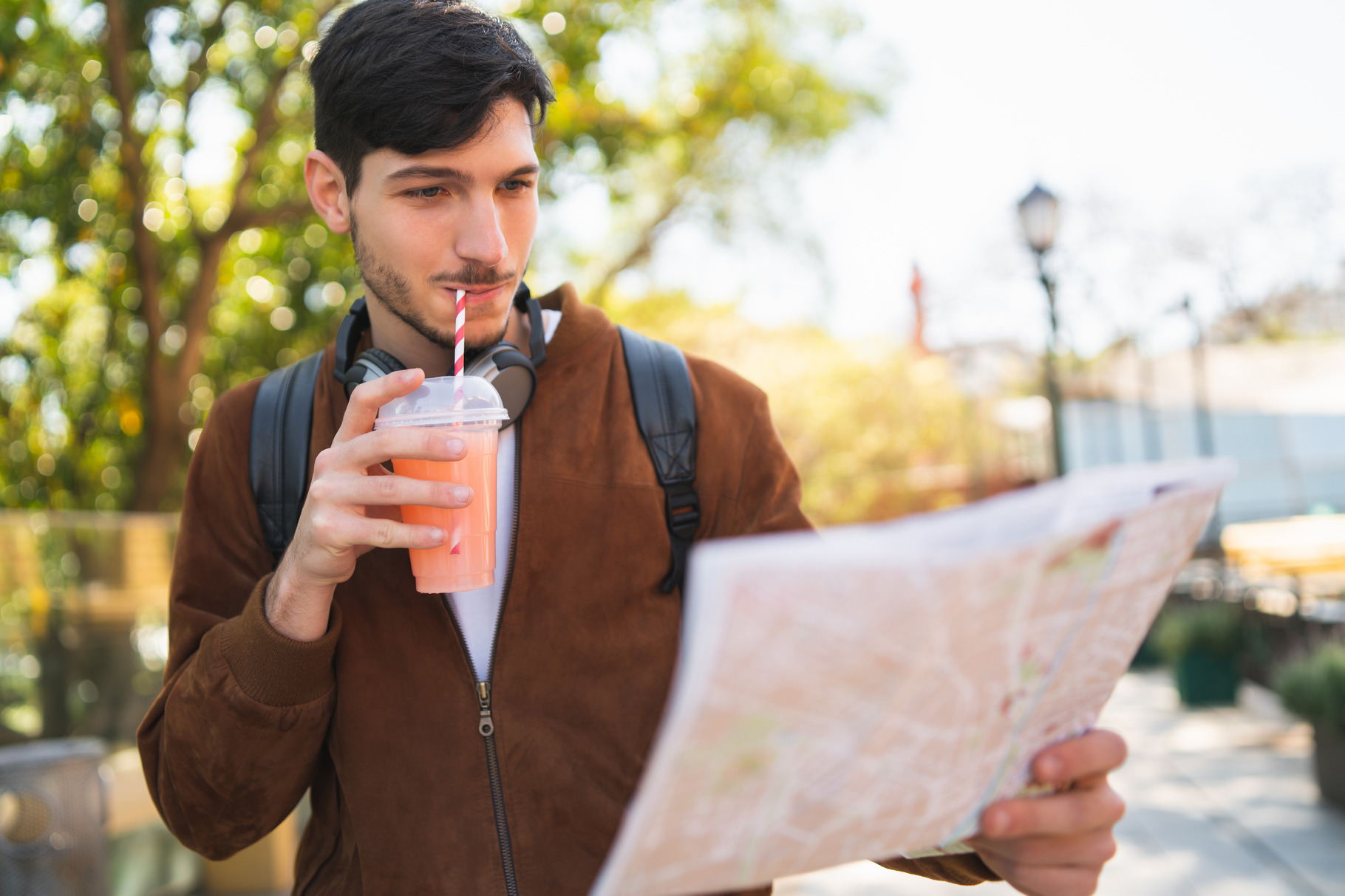Traveler man holding a map and looki, a Photo by Mego-studio