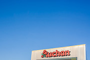 Auchan supermarket logo at its store featuring logo, sign, and chain, a ...