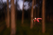 Man running through the trees on a blurred motion of forest, a Sports ...