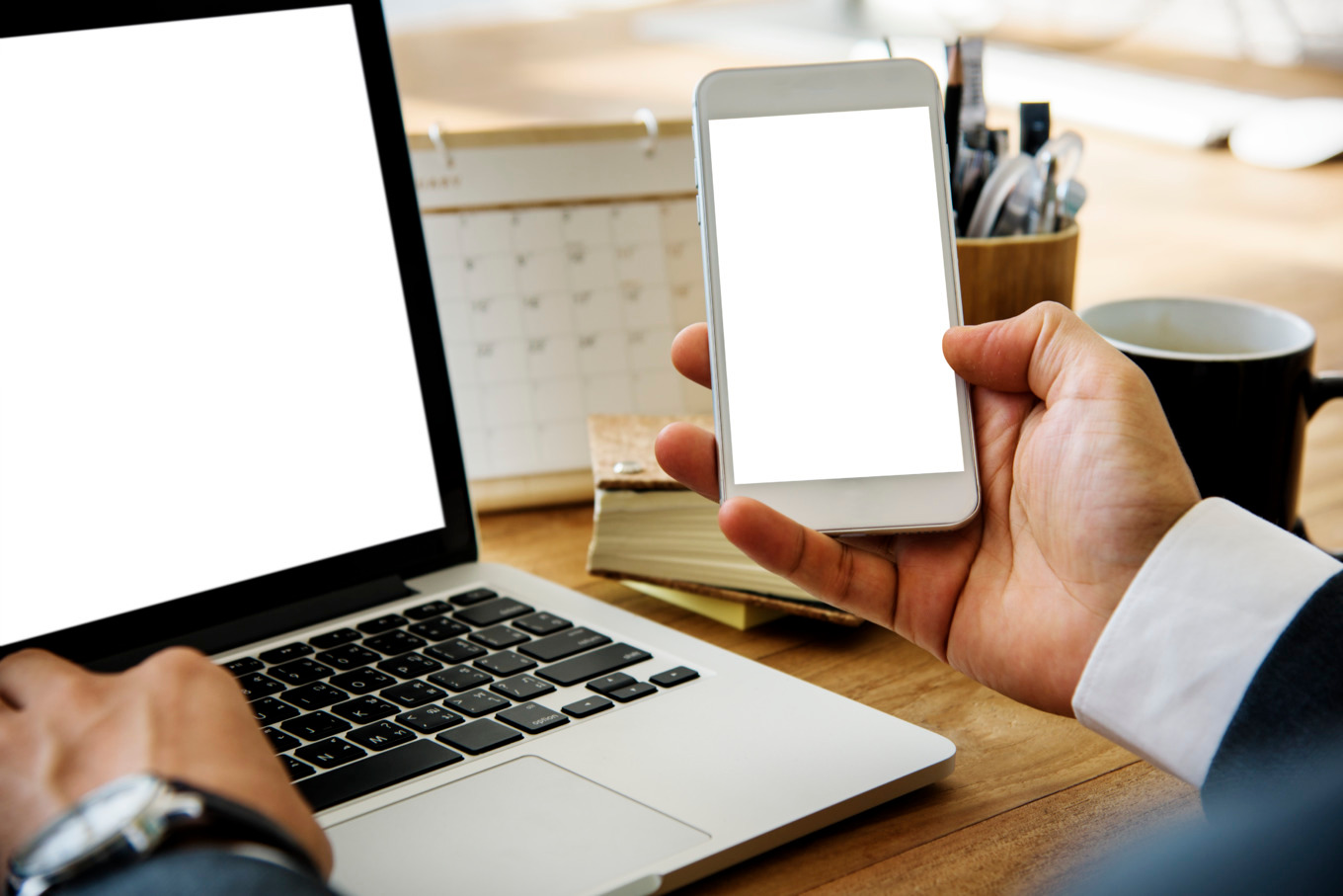 Working hold phone on a table png featuring png, cup, and plant, a ...