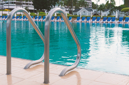 Blue swimming pool at hotel featuring pool, swimming, and tile, a ...