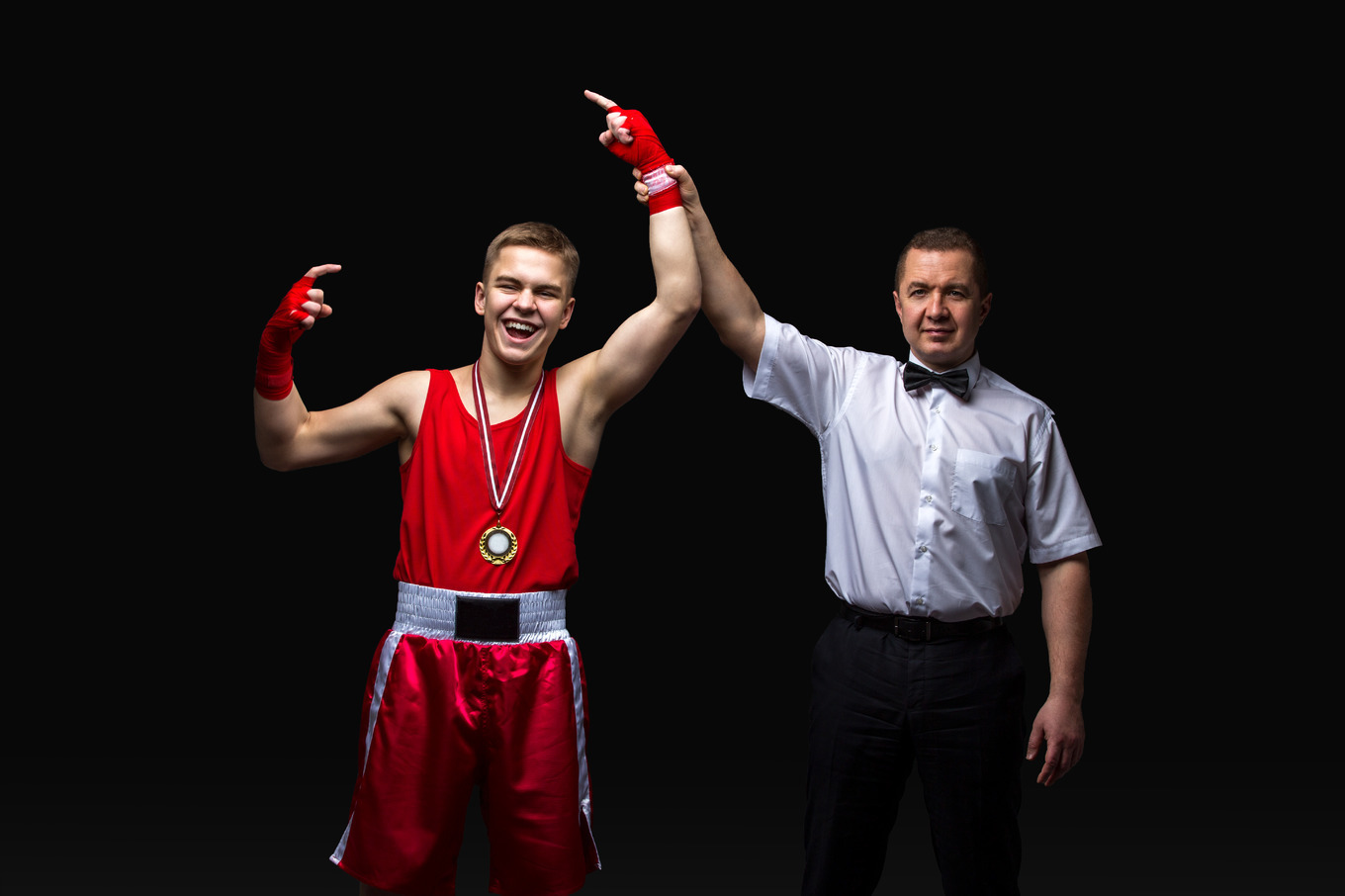 Boxing referee gives medal to young boxer containing boxer, young, and ...